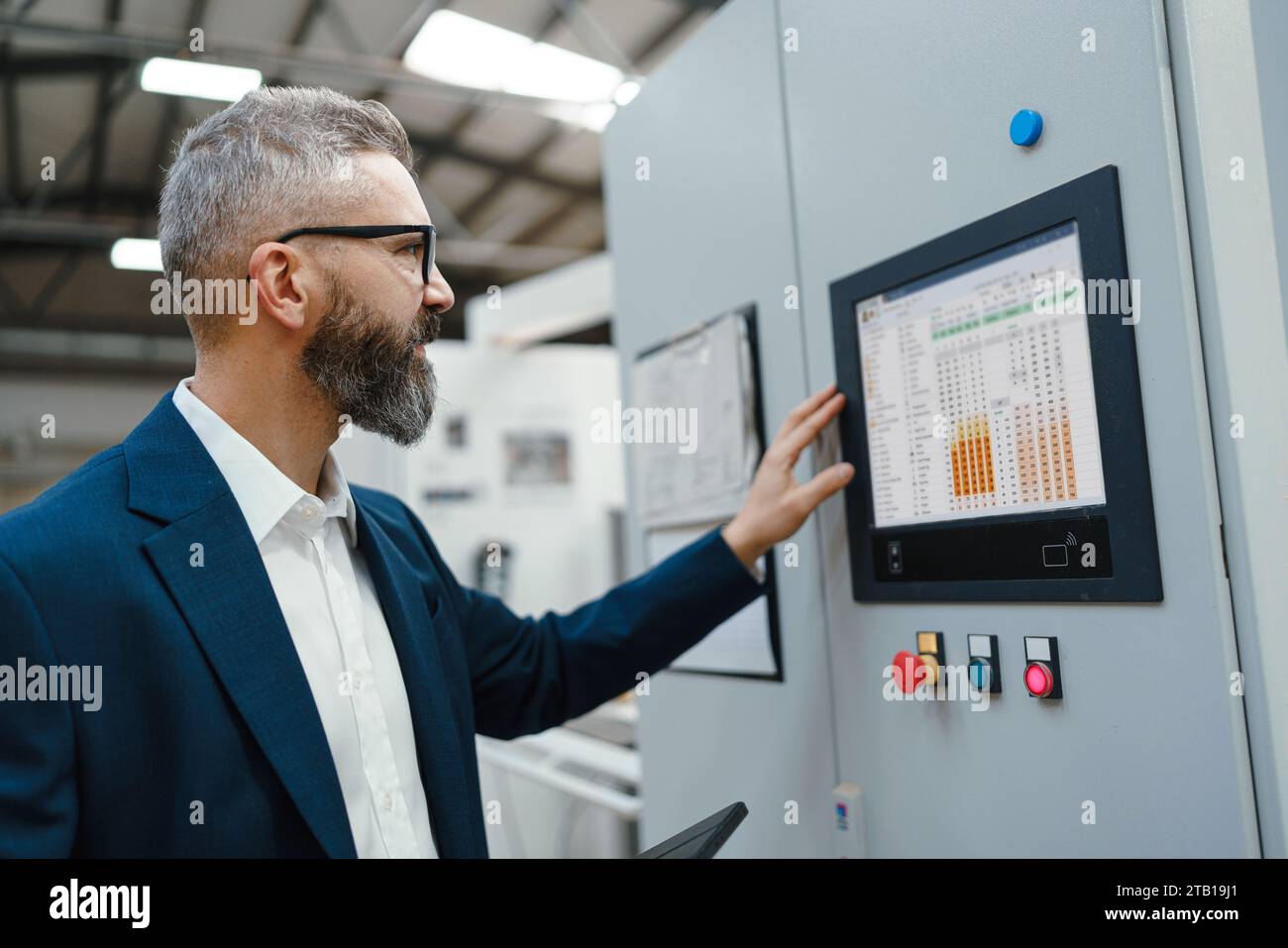 Production manager standing in modern industrial factory, controlling ...