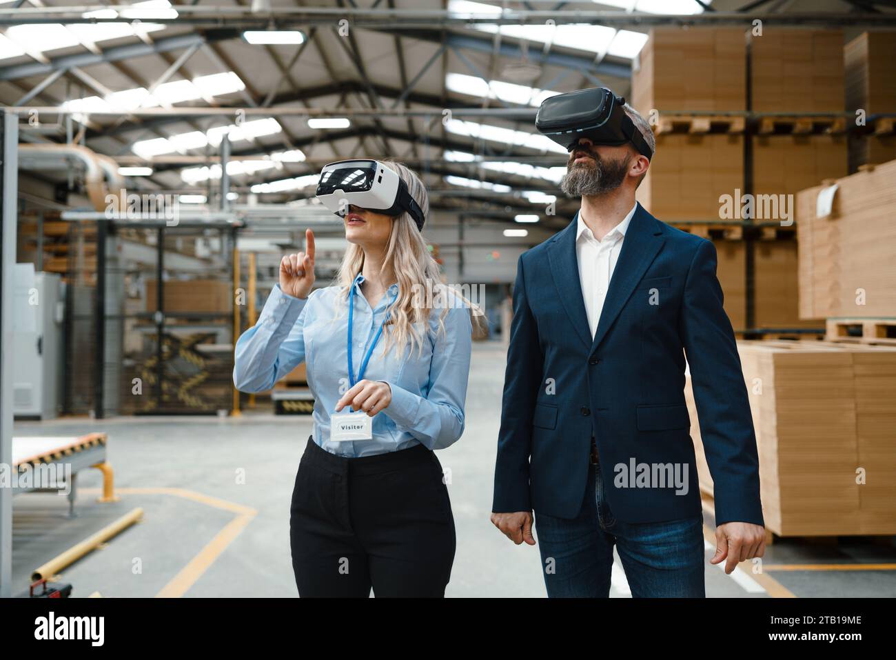 Engineers talking project using VR, in modern industrial factory. Virtual reality in ...