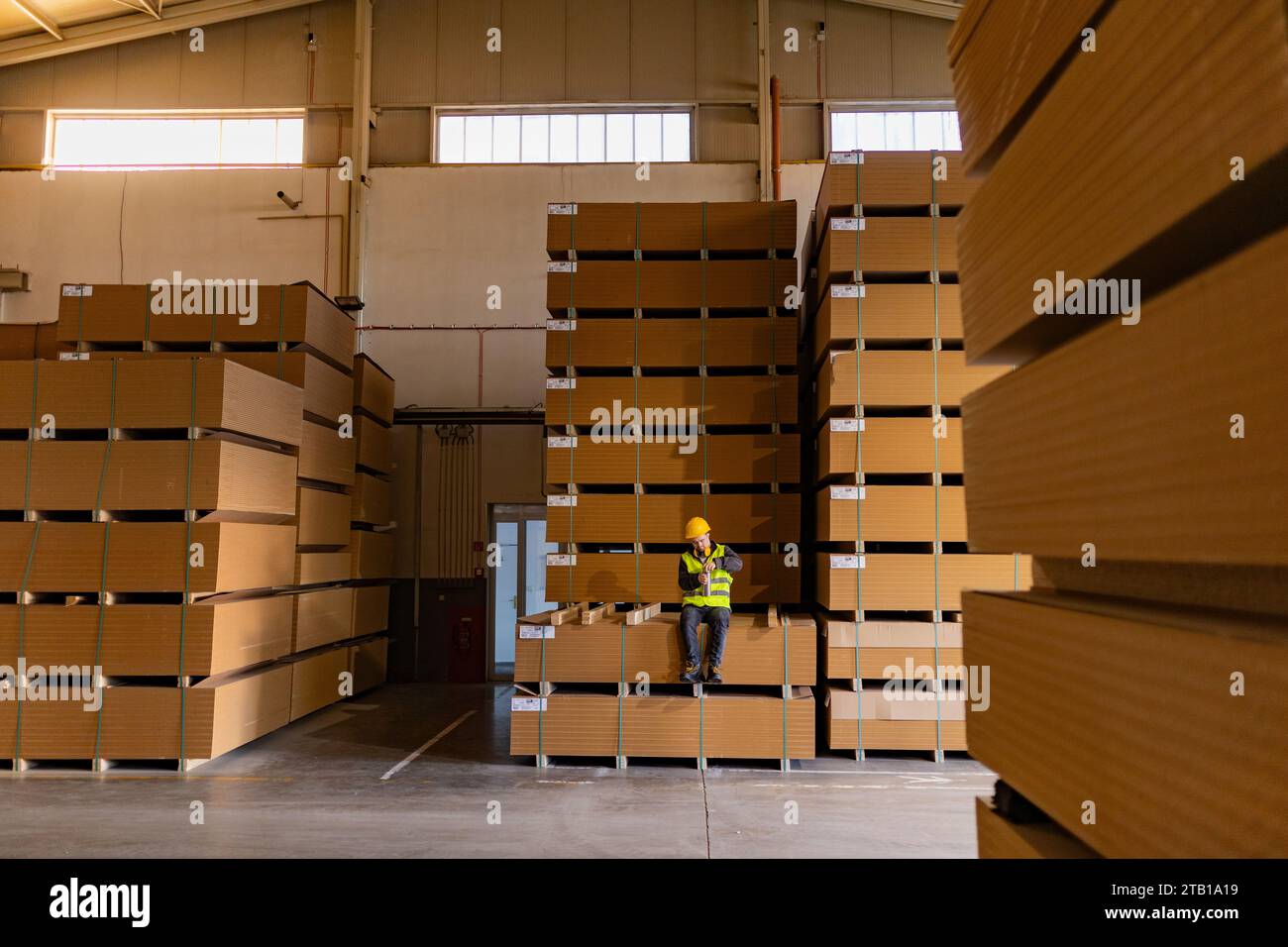 Worker with Down syndrome having break in factory, warehouse, drinking ...