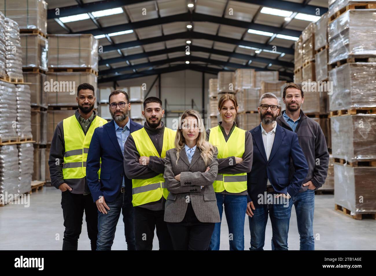Full team of warehouse employees standing in warehouse. Team of workers ...
