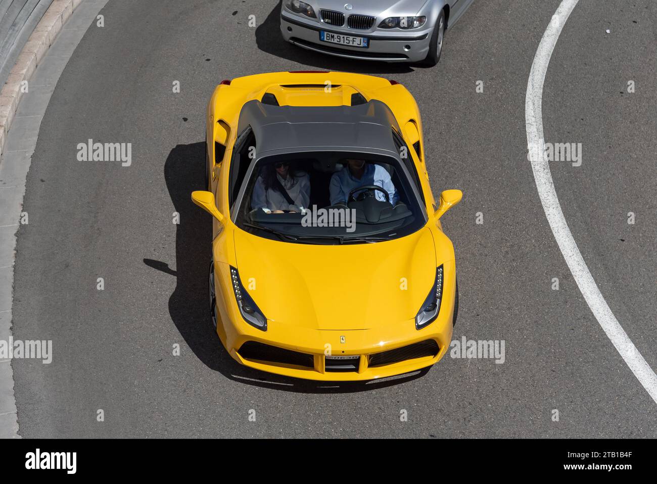 Monaco, Monaco - Yellow Ferrari 488 Spider driving on the road in the ...