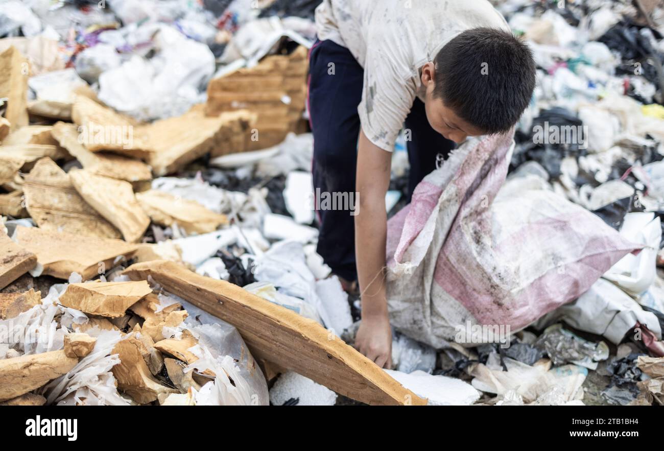 Poor children on the garbage dump and selecting plastic waste to sell ...