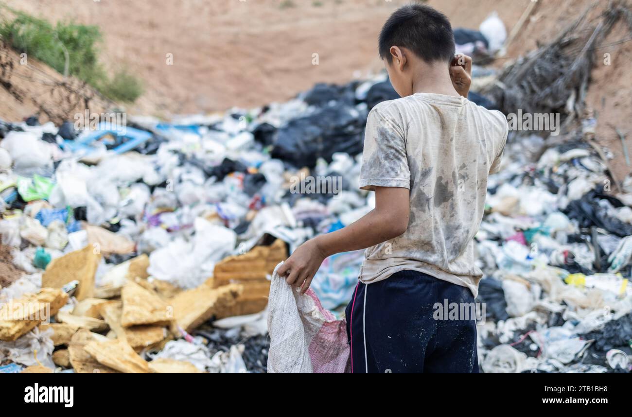 Poor children on the garbage dump and selecting plastic waste to sell ...