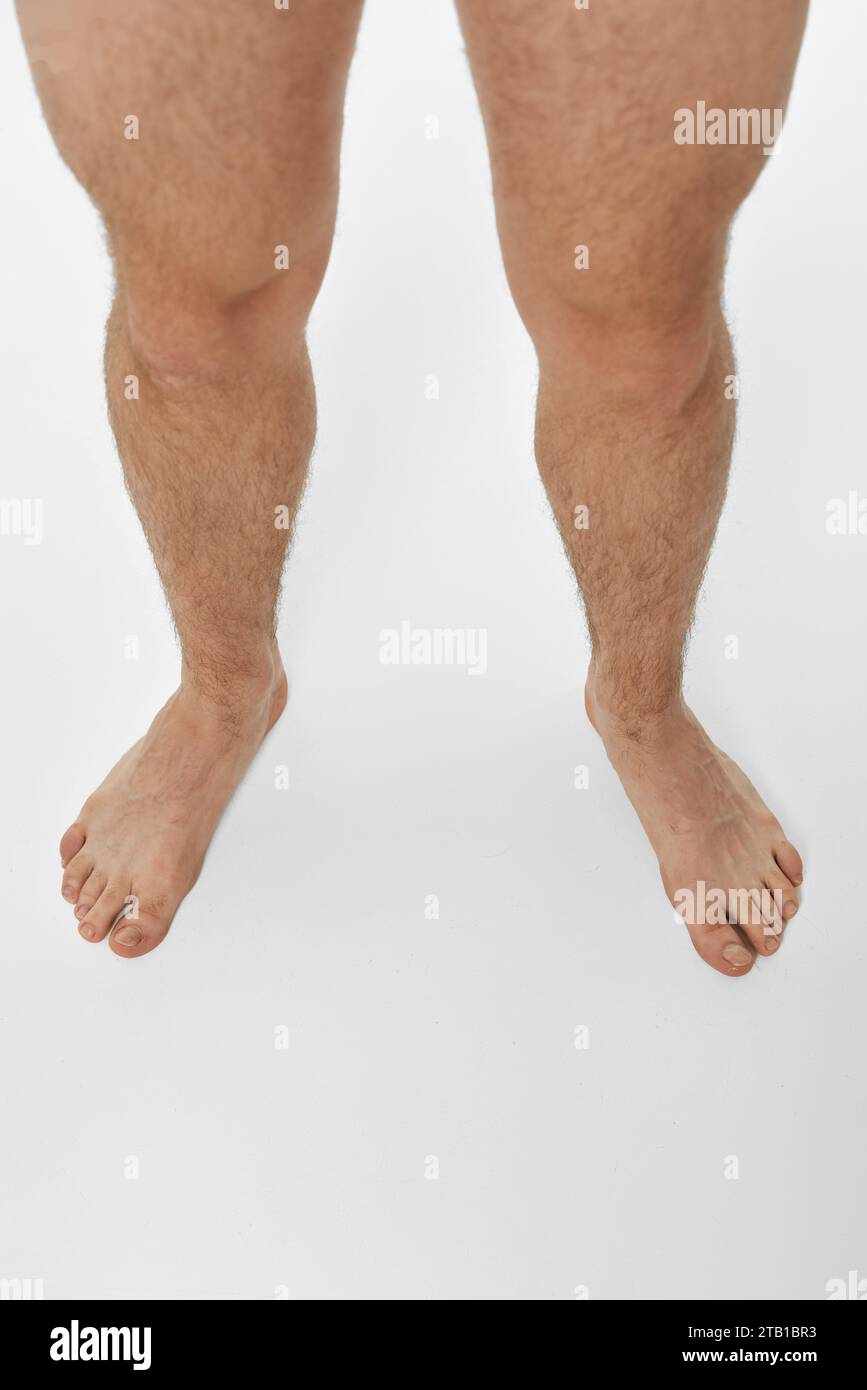 Barefoot male legs on white background. top view Stock Photo - Alamy