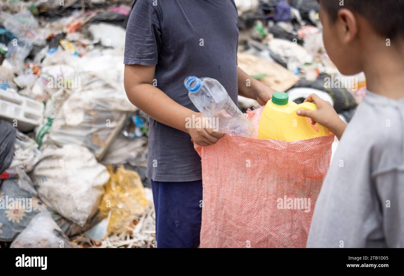 Poor children on the garbage dump and selecting plastic waste to sell ...