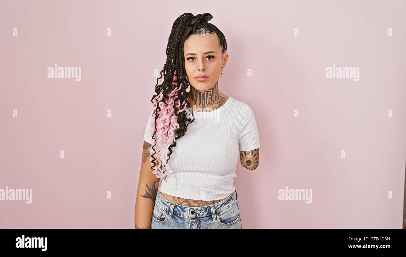 Cool hispanic amputee woman, standing over pink isolated background ...