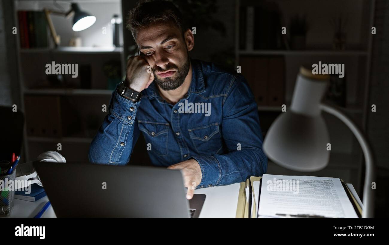 Overworked and sleepy young hispanic businessman caught in late-night ...
