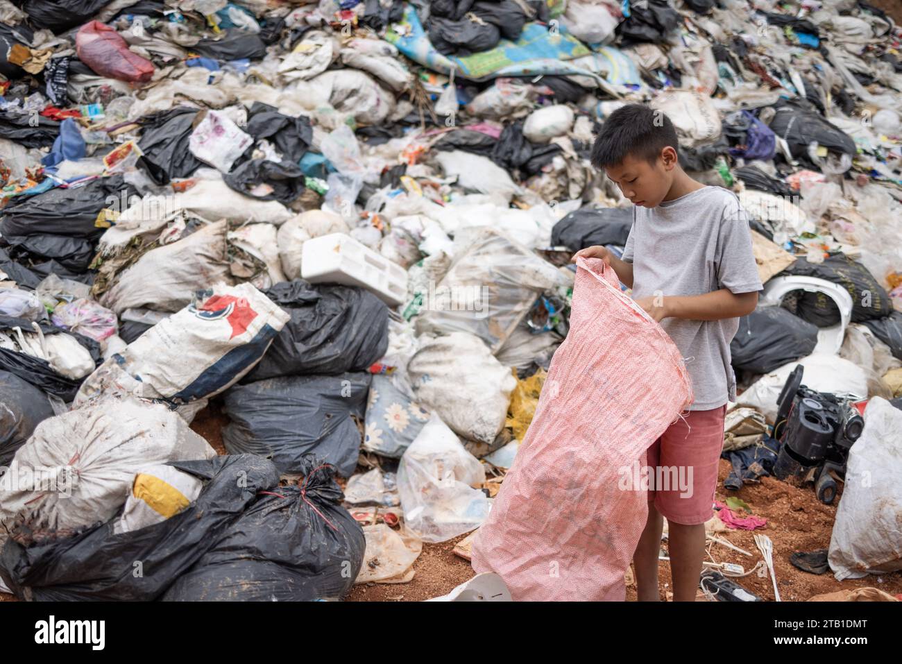 Poor children on the garbage dump and selecting plastic waste to sell ...