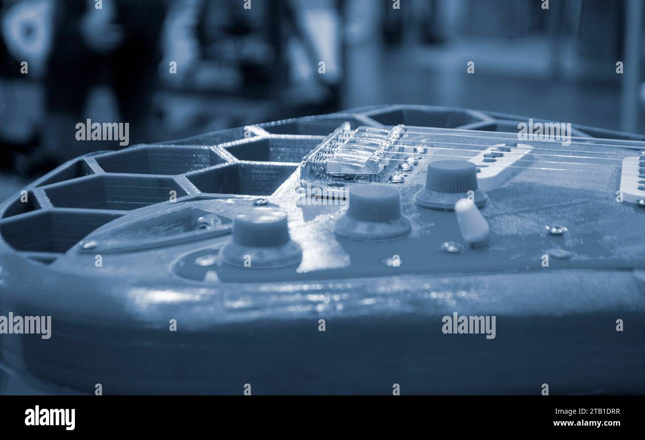 Musical instrument guitar 3D printed from molten plastic in yellow and ...