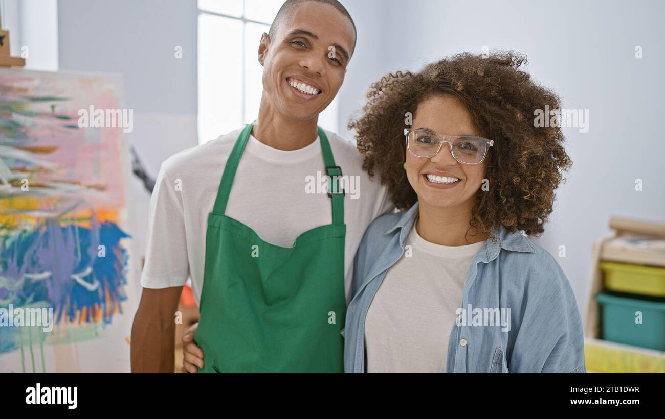 Confident artists, man and woman, share a joyous, smiling hug in their ...