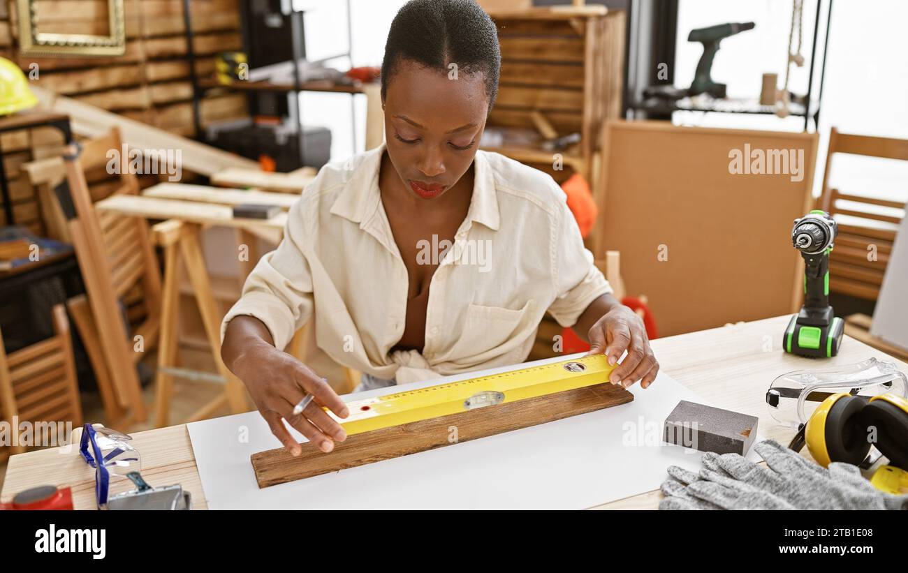 Beautiful african american woman carpenter measuring wood plank, a ...