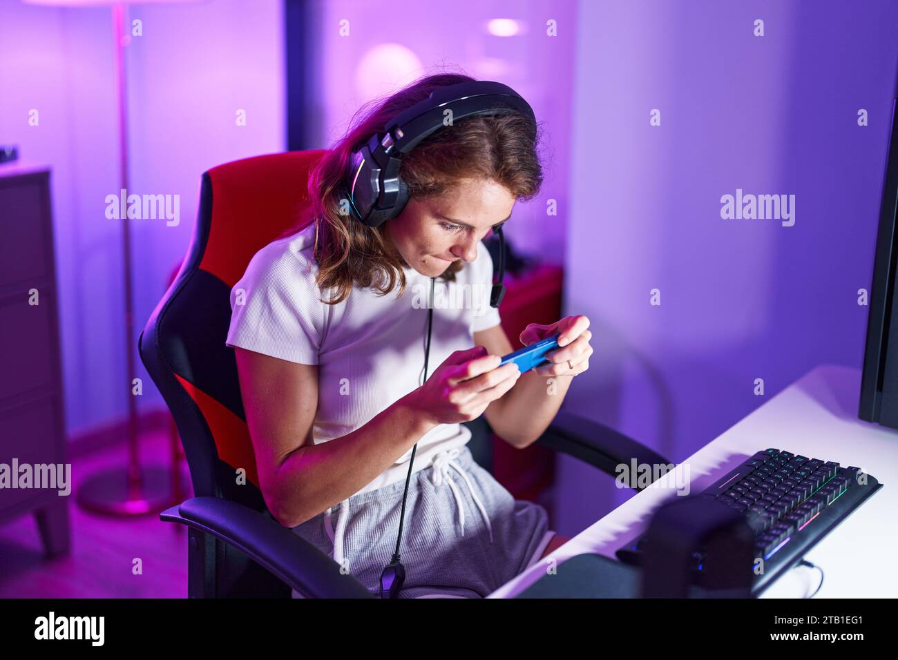 Young beautiful hispanic woman streamer playing video game using ...