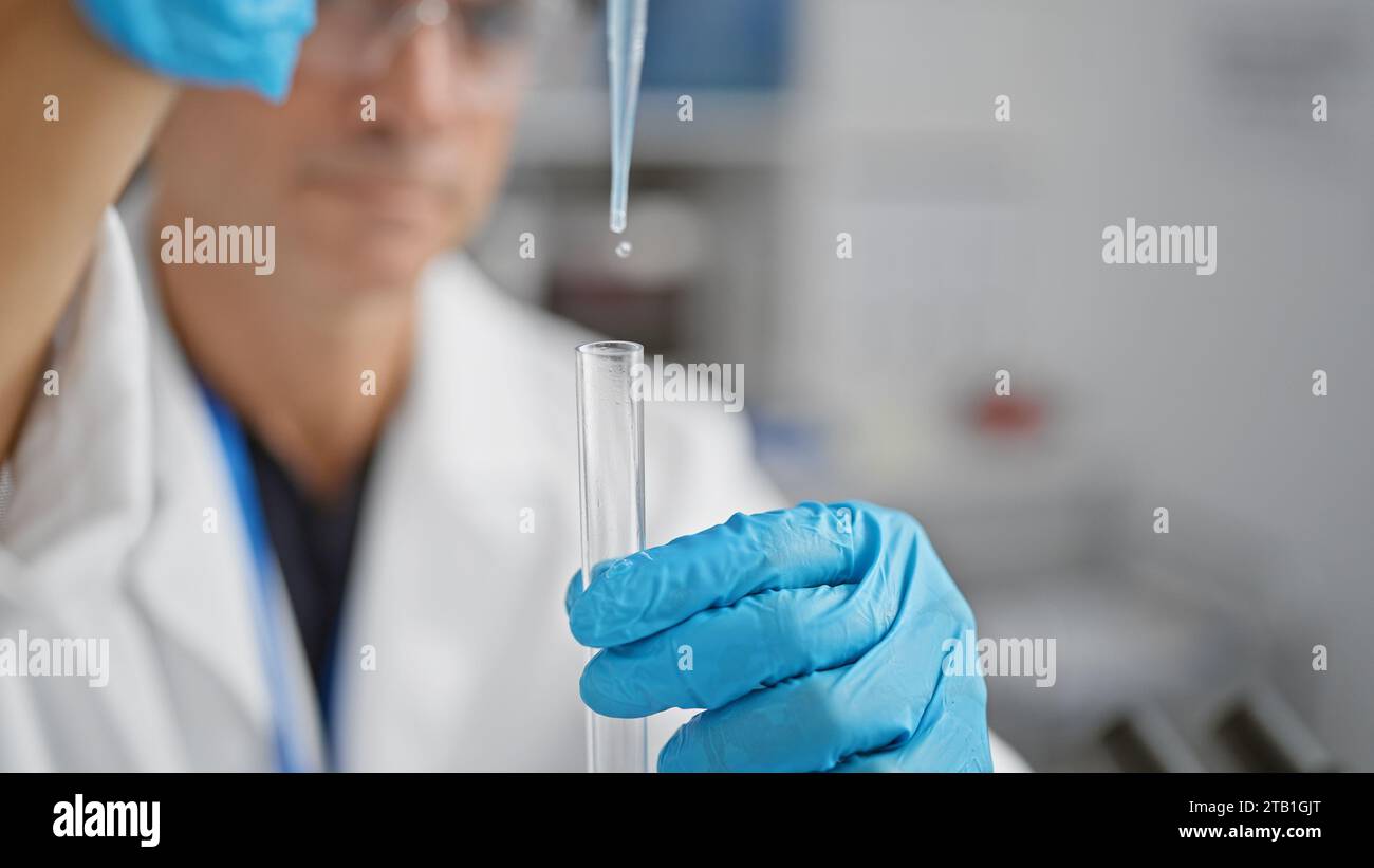 Senior male scientist measuring liquid hi-res stock photography and ...