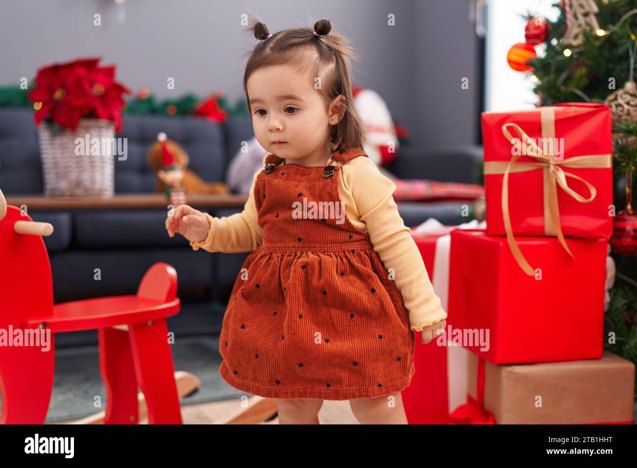 Adorable chinese toddler standing by christmas tree at home Stock Photo ...