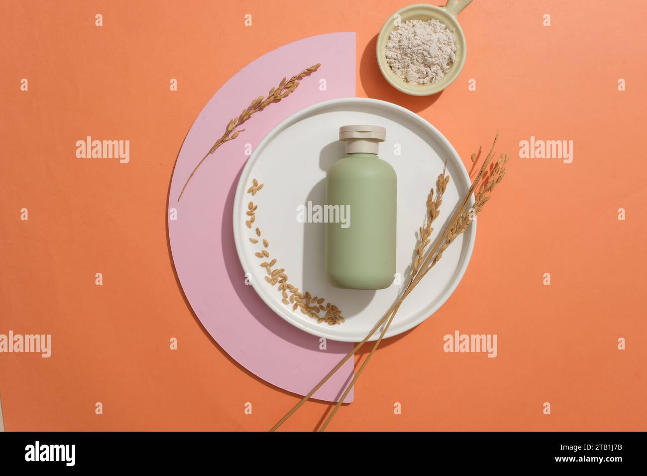Ceramic dish in round shaped with unbranded bottle placed on with wheat ...