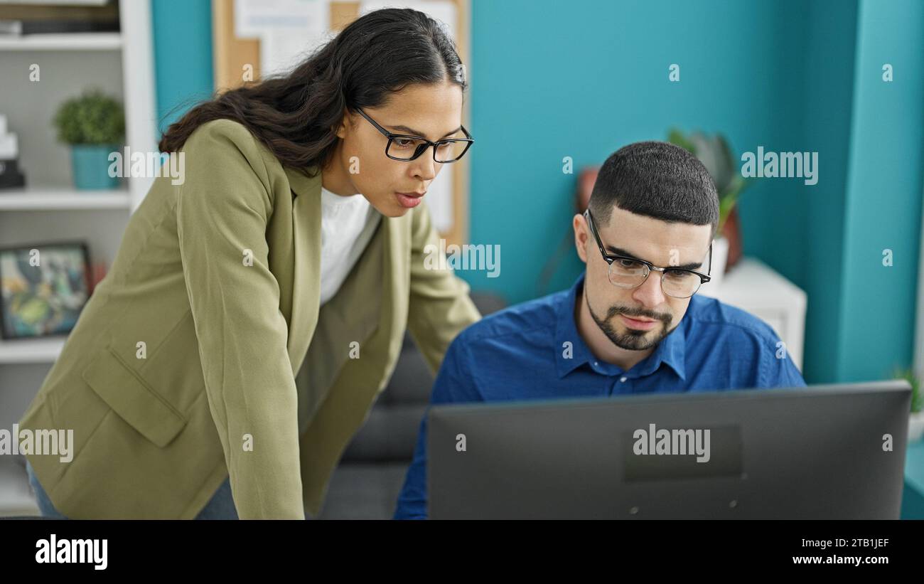 Dynamic duo at work, two professional workers, man and woman, conjuring ...