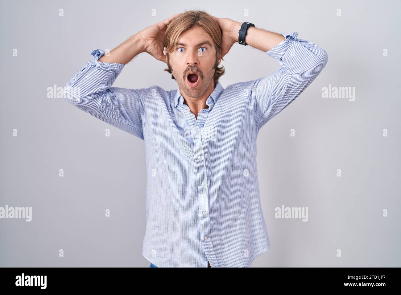 Caucasian man with mustache standing over white background crazy and ...