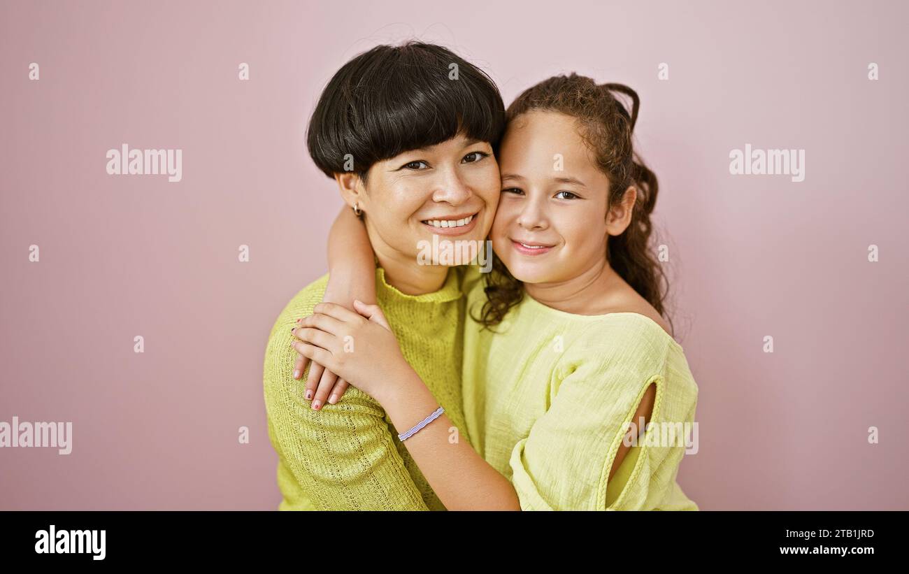 Confident mother and daughter sharing a lovely, happy hug while smiling ...