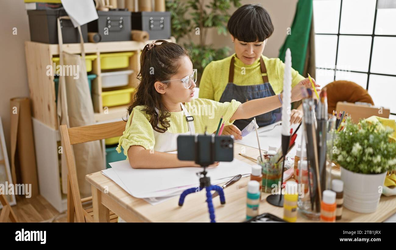Cheerful student and her art teacher-artist engage in drawing lesson ...