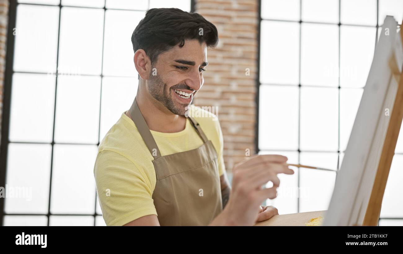 Young hispanic man artist smiling confident drawing at art studio Stock ...