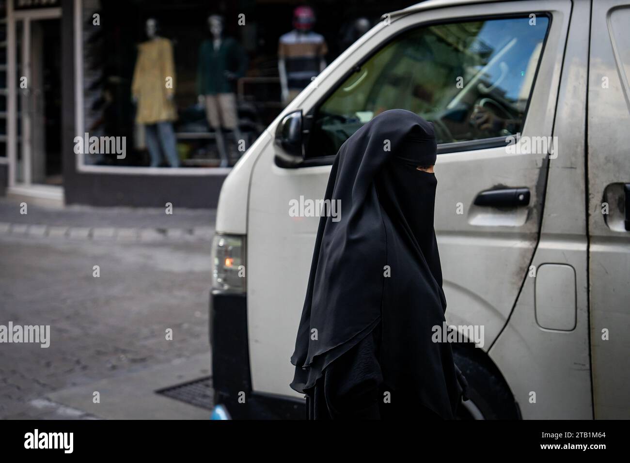 Maldives. 04th Dec, 2023. A muslim woman wearing a burqa walks down the ...