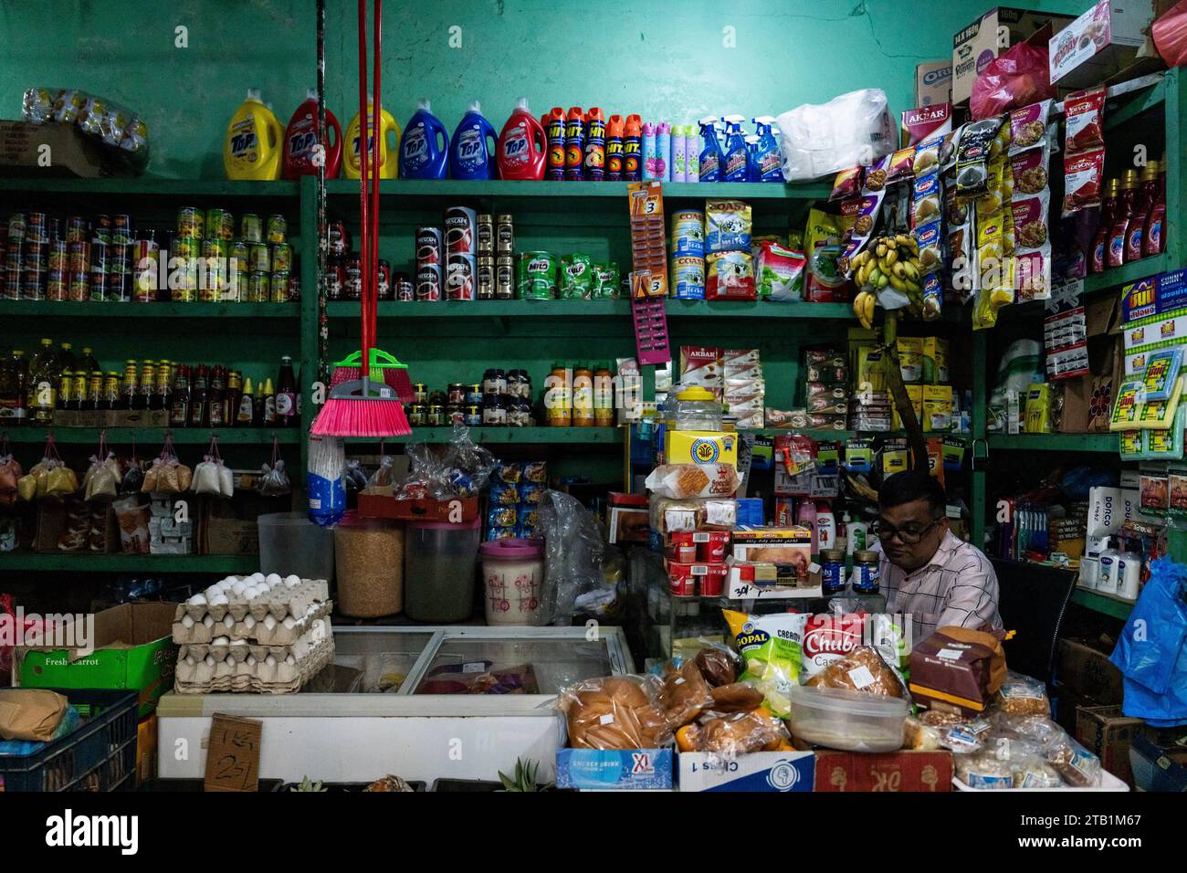 Maldives. 04th Dec, 2023. A convenience store owner checks their ...