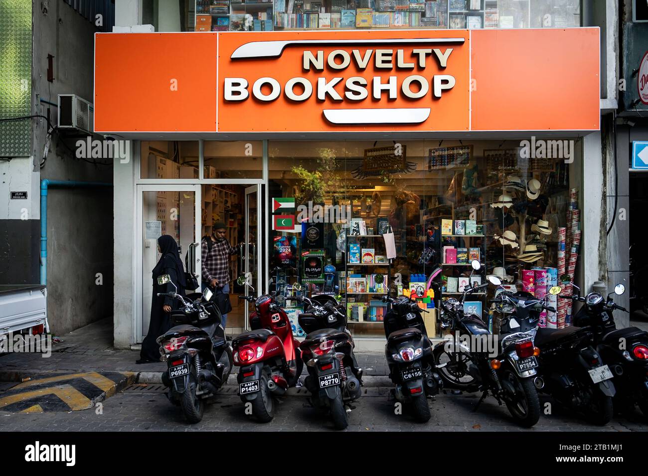 Maldives. 04th Dec, 2023. A woman wearing a burqa walks out of a ...