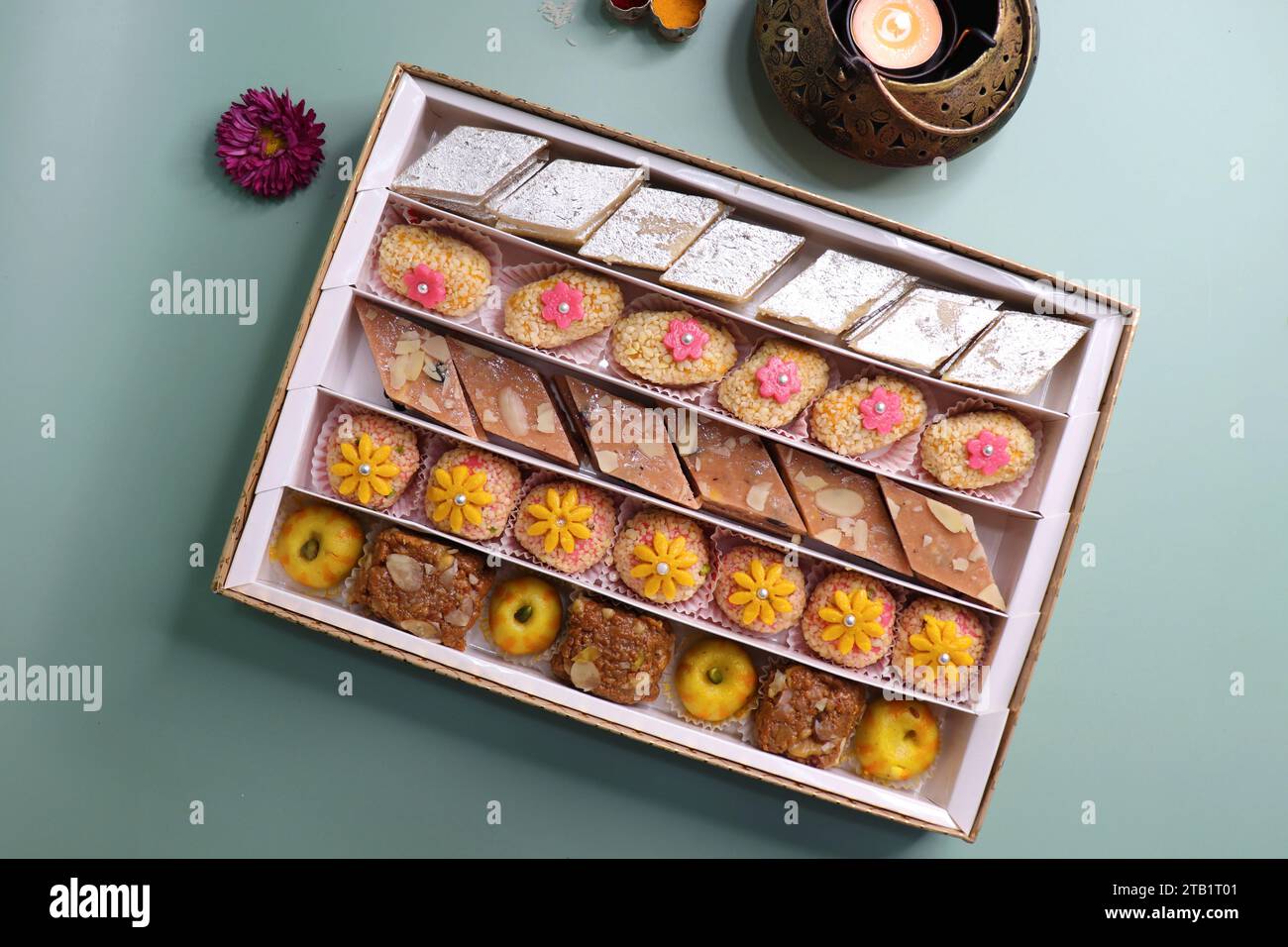 Indian assorted Diwali sweets or mithai with diya and flowers. Festive ...