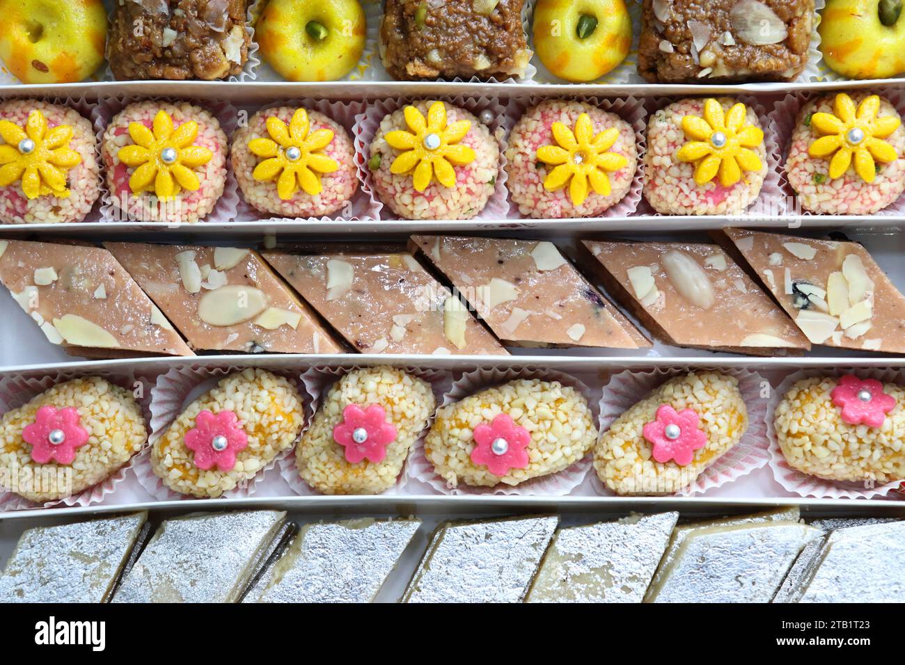 Indian assorted Diwali sweets or mithai with diya and flowers. Festive ...