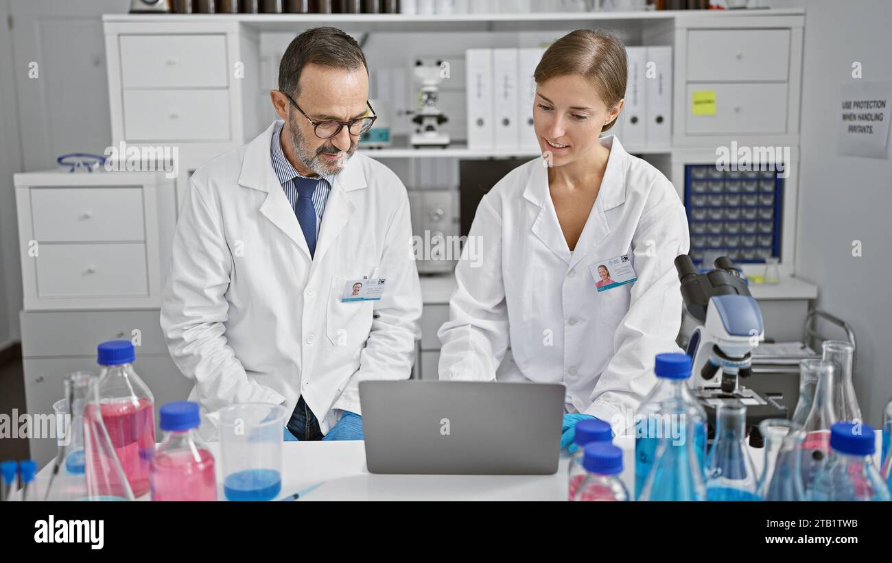 Two serious scientists in glasses, engrossed in a vital research ...