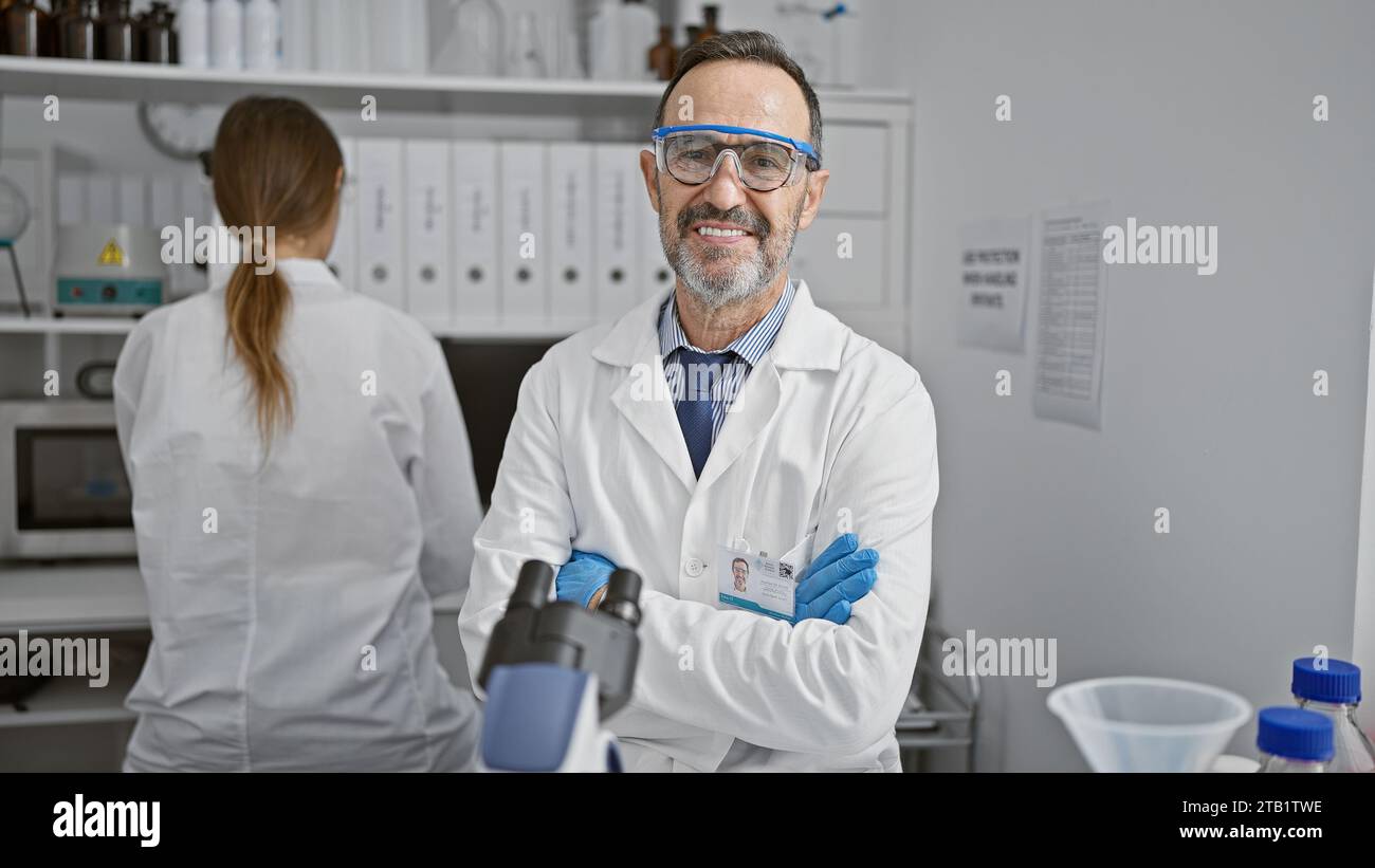 Two amiable scientists, best mates, sitting with arms crossed ...