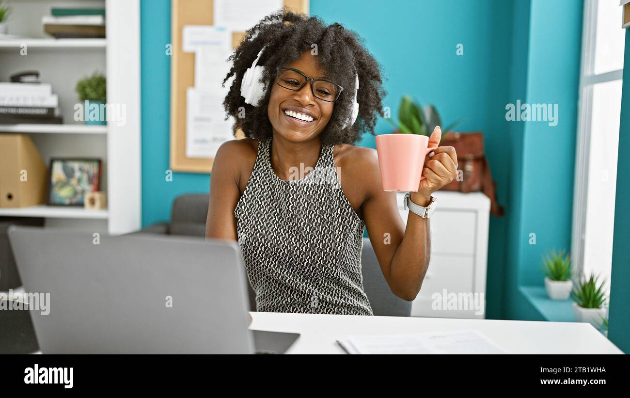 African american woman business worker listening to music drinking ...