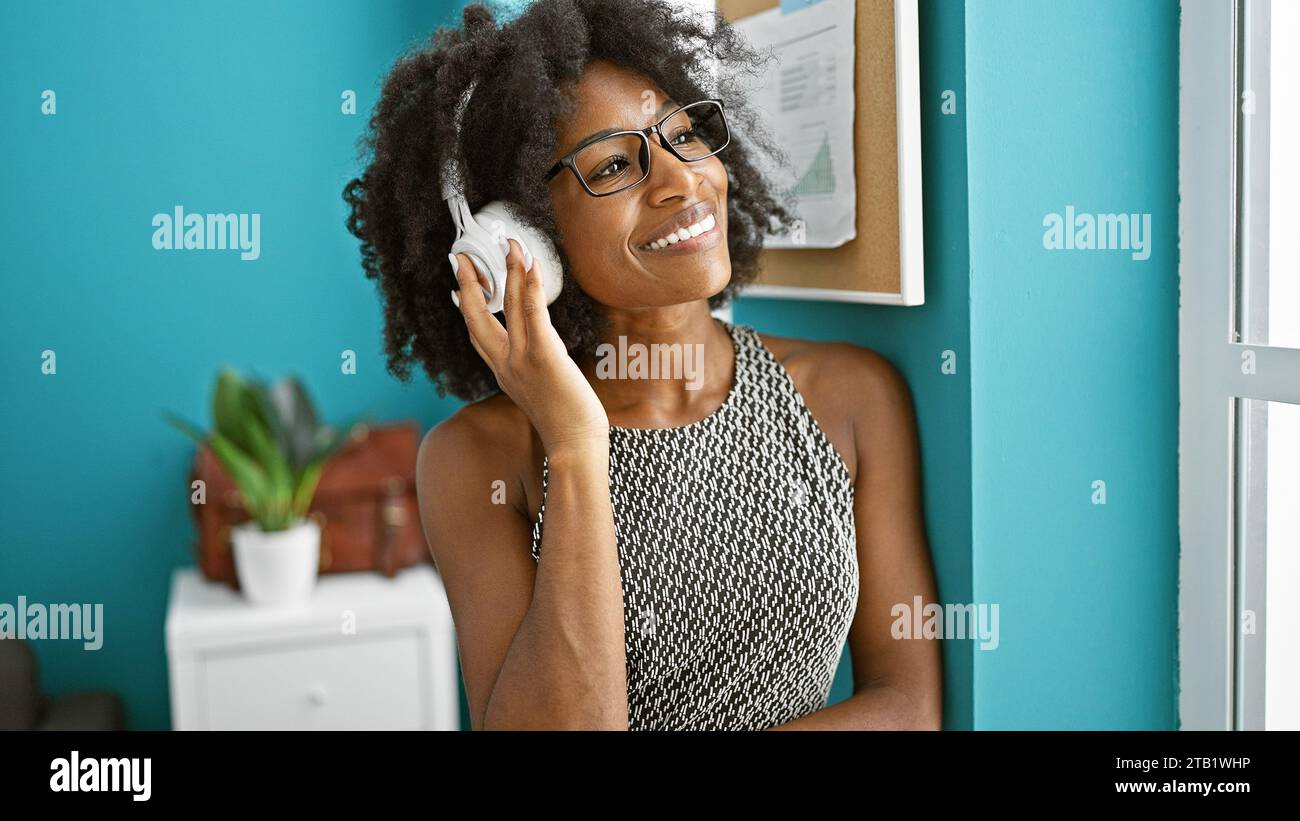 African american woman business worker listening to music smiling at ...