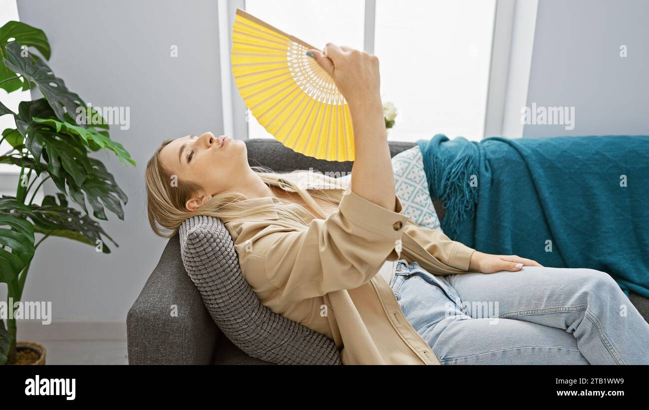 Stunning young blonde woman suffering in hot weather indoors ...