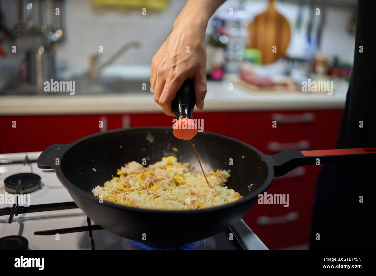 Hands of a young man making fried rice with eggs in a work, asian ...