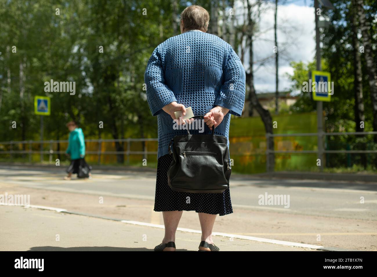 Woman waiting at bus stop hi-res stock photography and images - Alamy