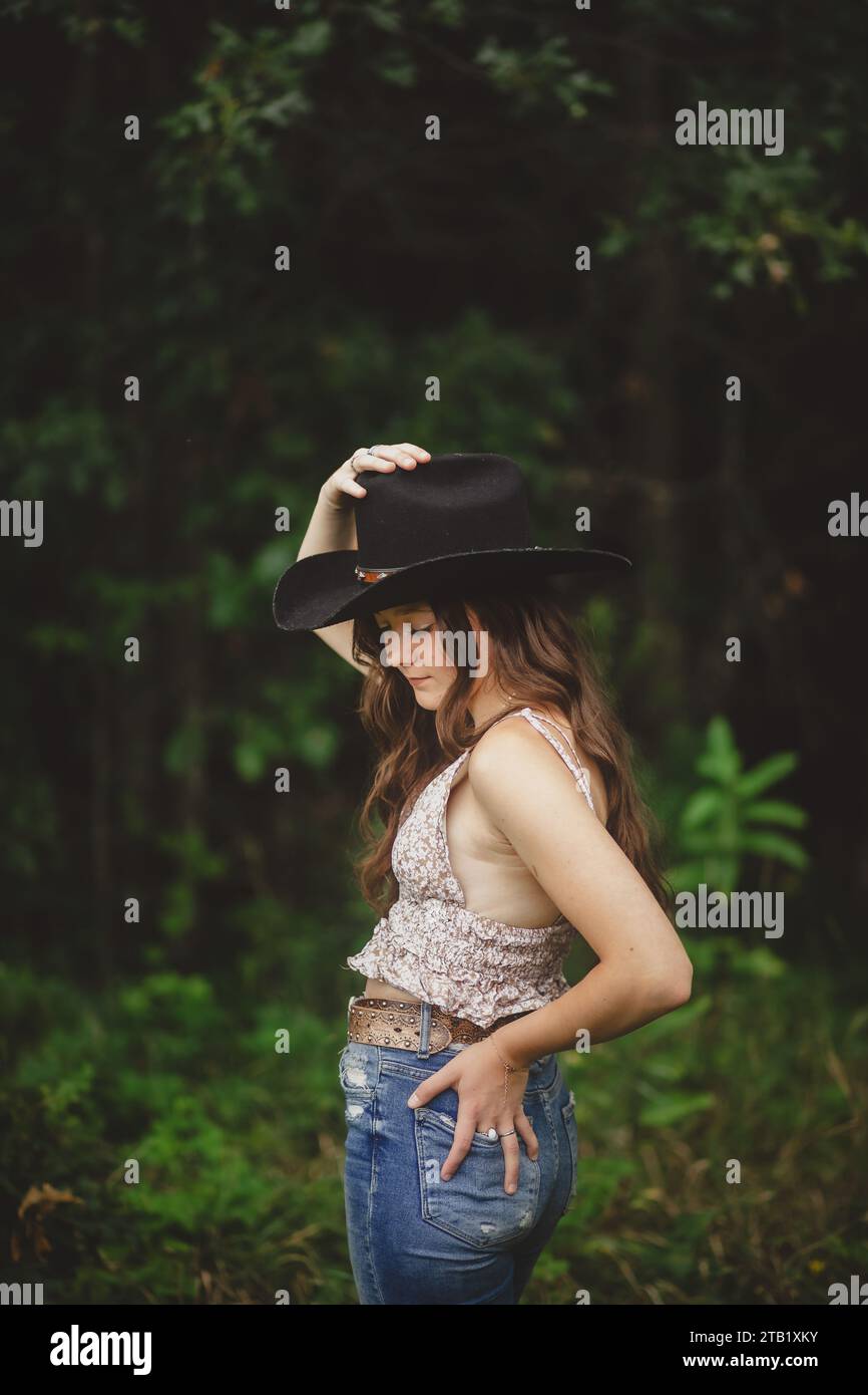 Portrait of a female in cowboy hat posing outdoors Stock Photo - Alamy