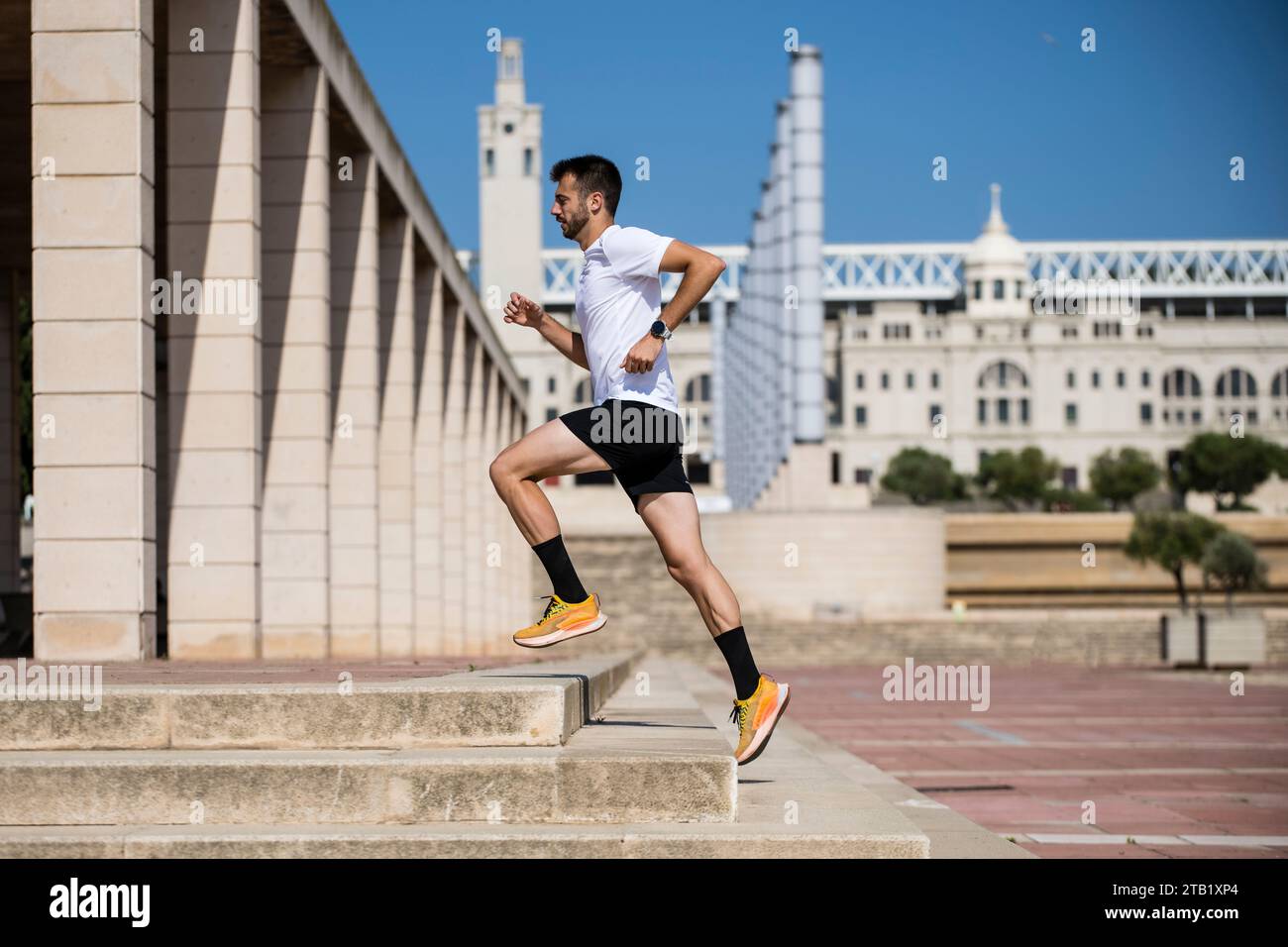 Male runner training by climbing stairs outdoors Stock Photo - Alamy