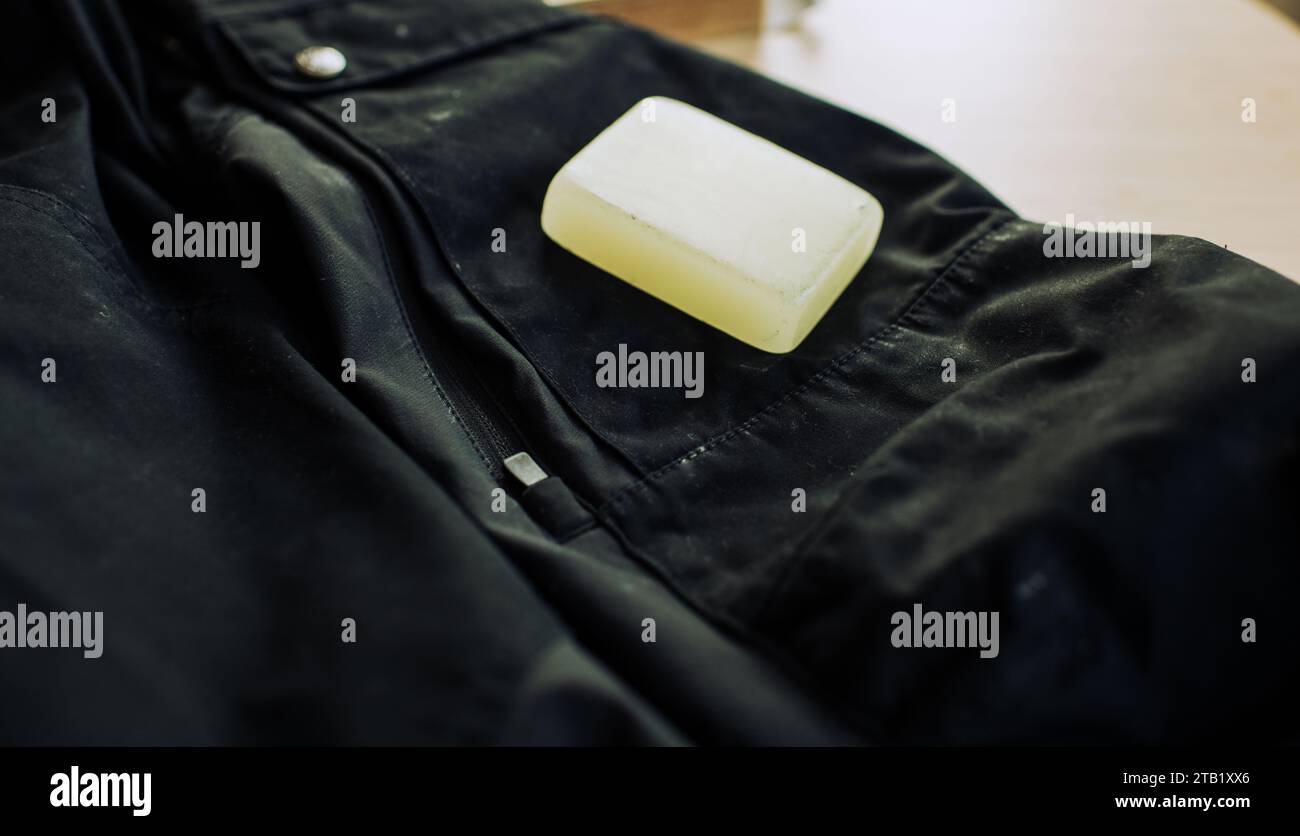 bar of wax on a pair of hiking trousers ready for waterproofing Stock ...
