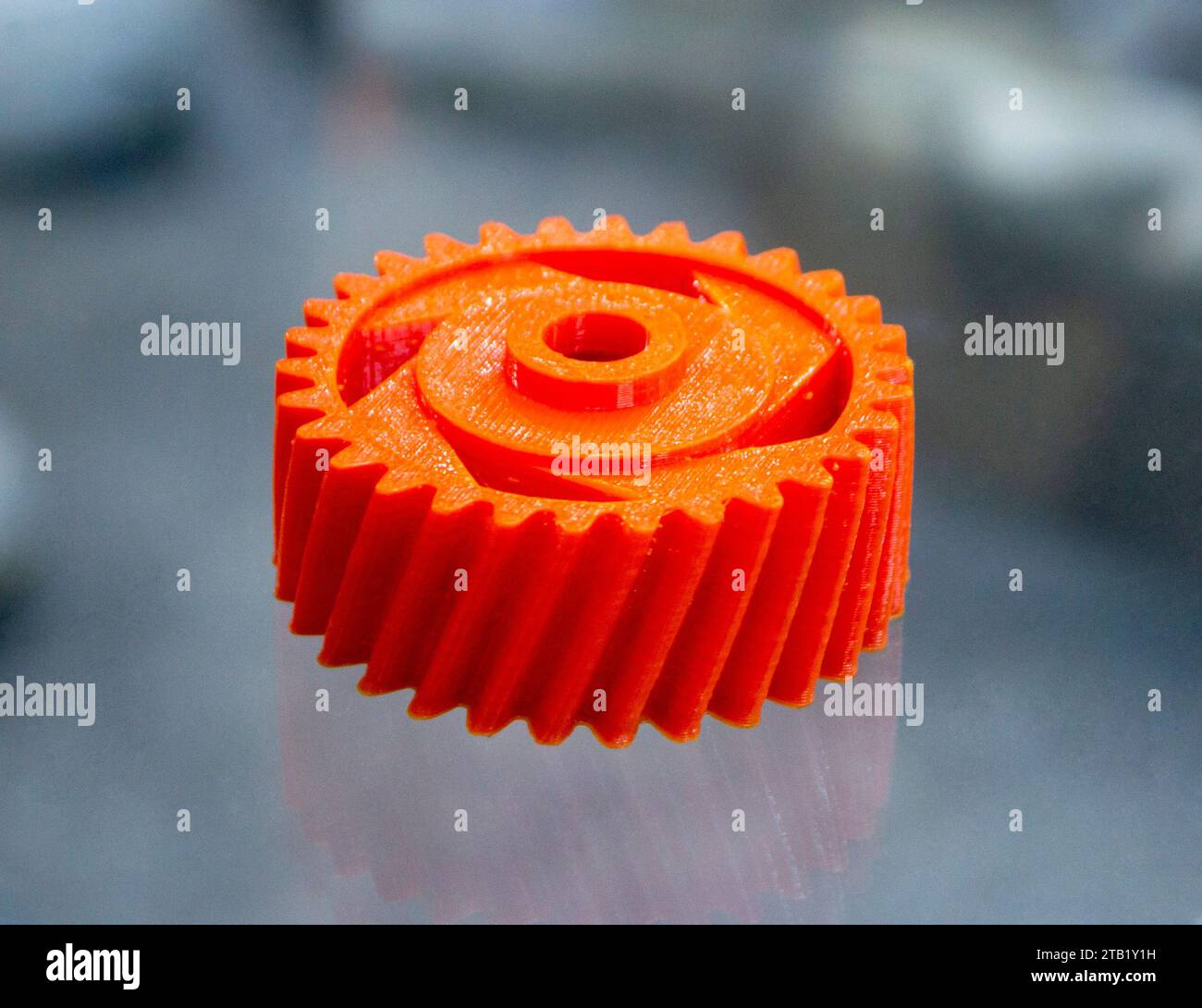 Many orange detail printed on 3D printer close-up. Part 3D printed from ...