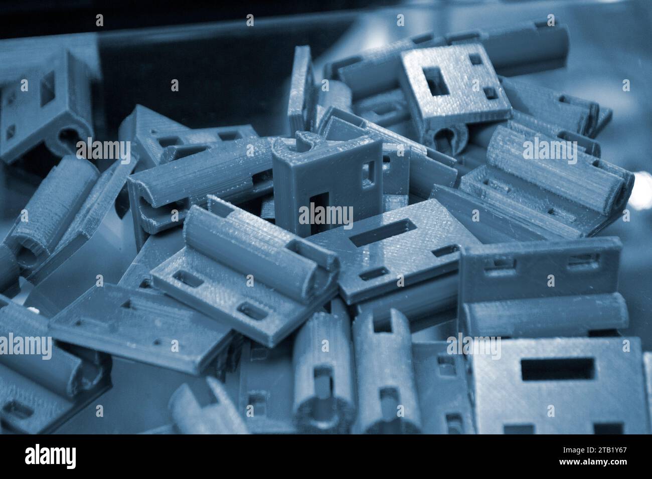 Many blue details printed on 3D printer close-up. Parts 3D printed from ...