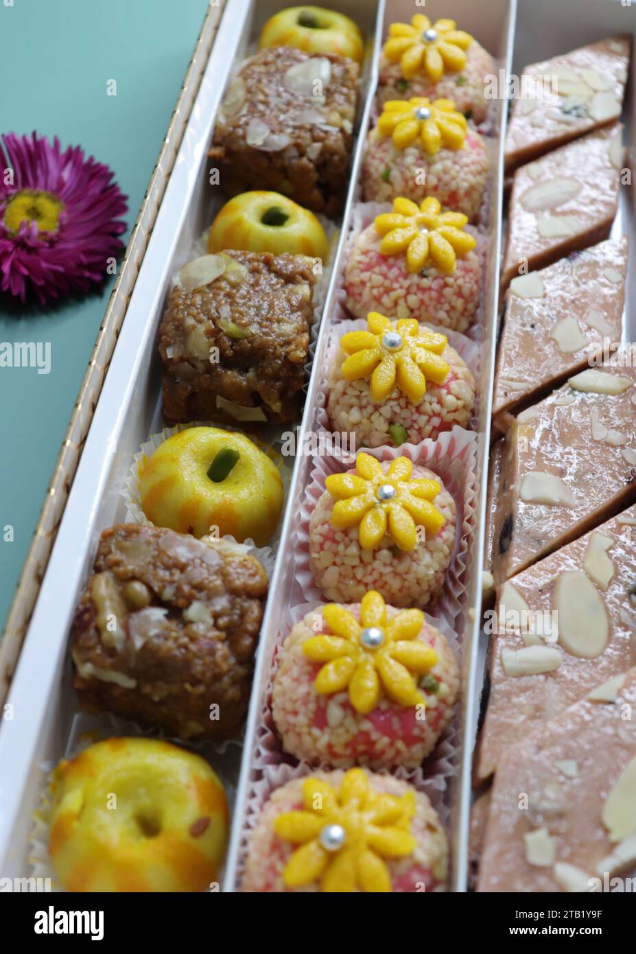 Indian assorted Diwali sweets or mithai with diya and flowers. Festive ...