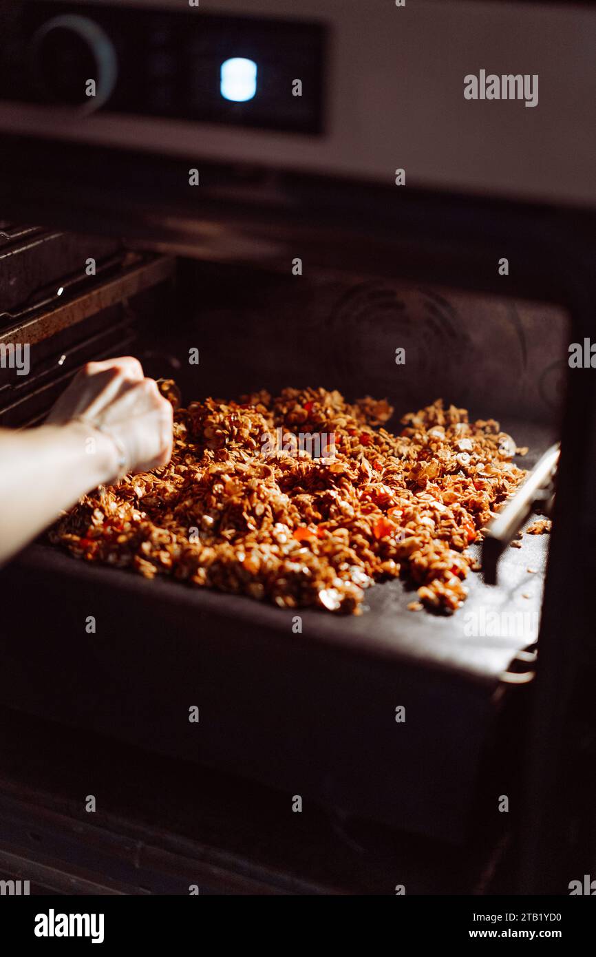 Making homemade oatmeal granola. Rice flakes, nuts and candied fruits ...
