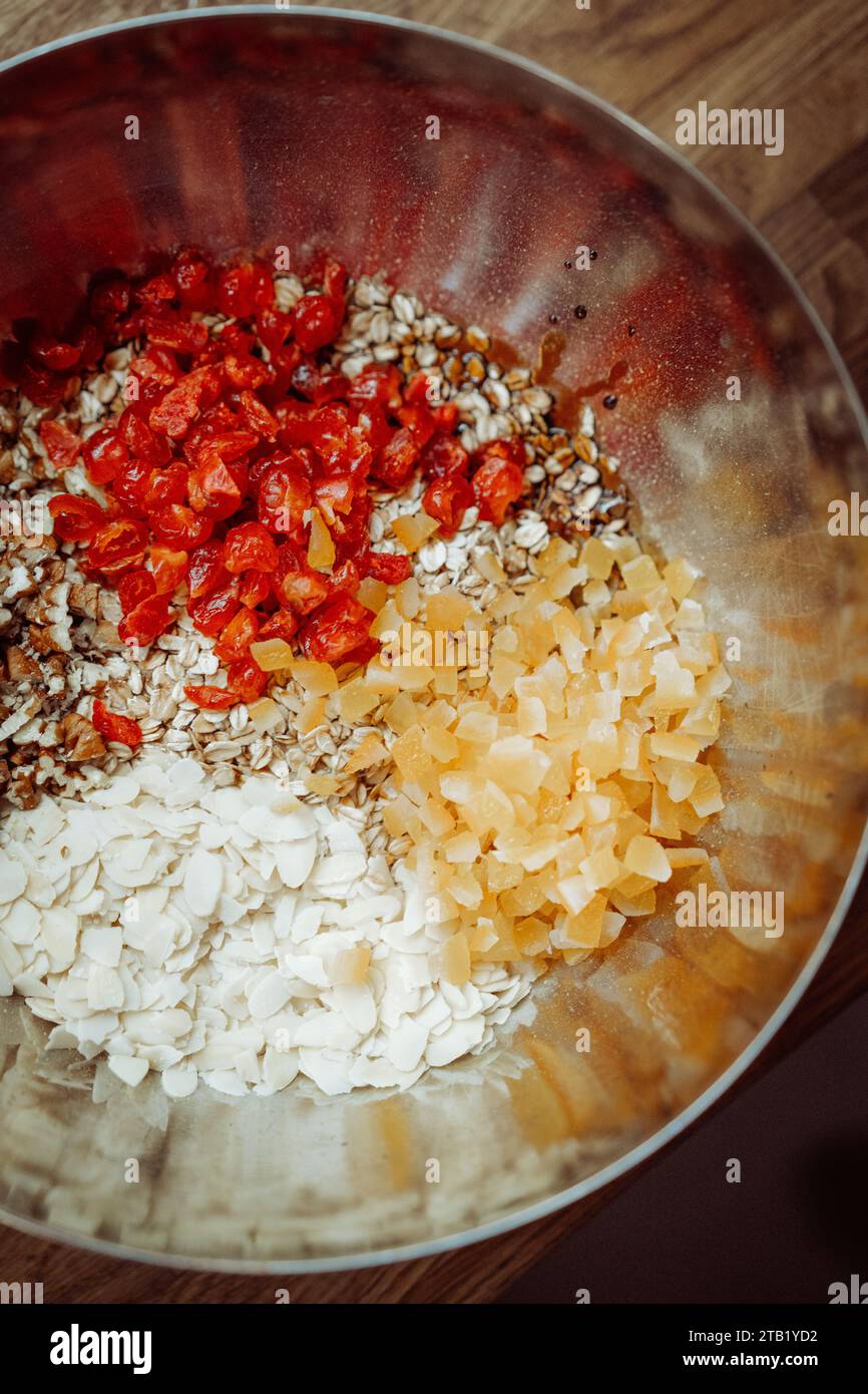 Making homemade oatmeal granola. Rice cereal, nuts and candied fruits ...