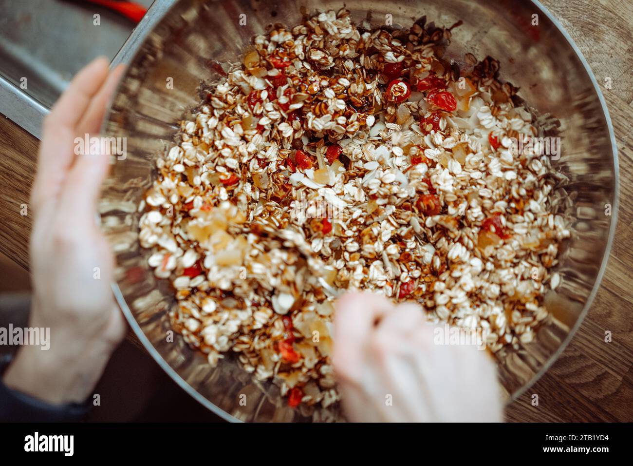 Making homemade oatmeal granola. Rice flakes, nuts and candied fruits ...