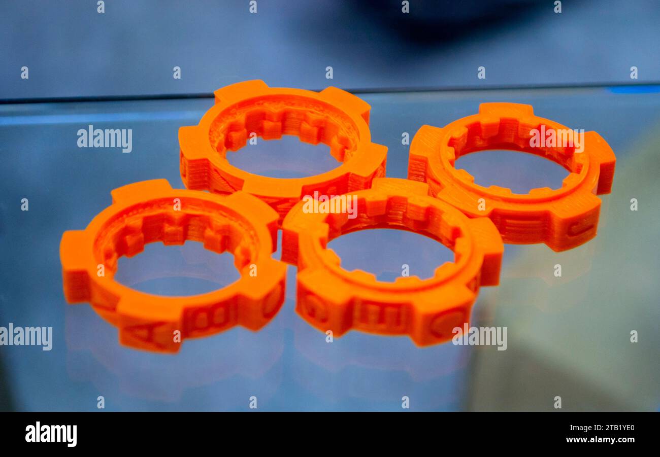Many orange detail printed on 3D printer close-up. Part 3D printed from ... Many orange detail printed on 3D printer close-up. Part 3D printed from ...