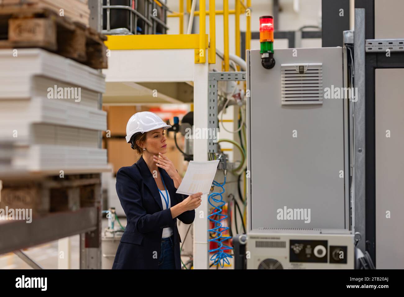 Female manager standing in modern industrial factory. Manufacturing ...