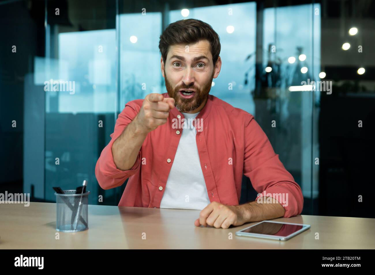Upset unhappy and sad man inside office at workplace talking with ...