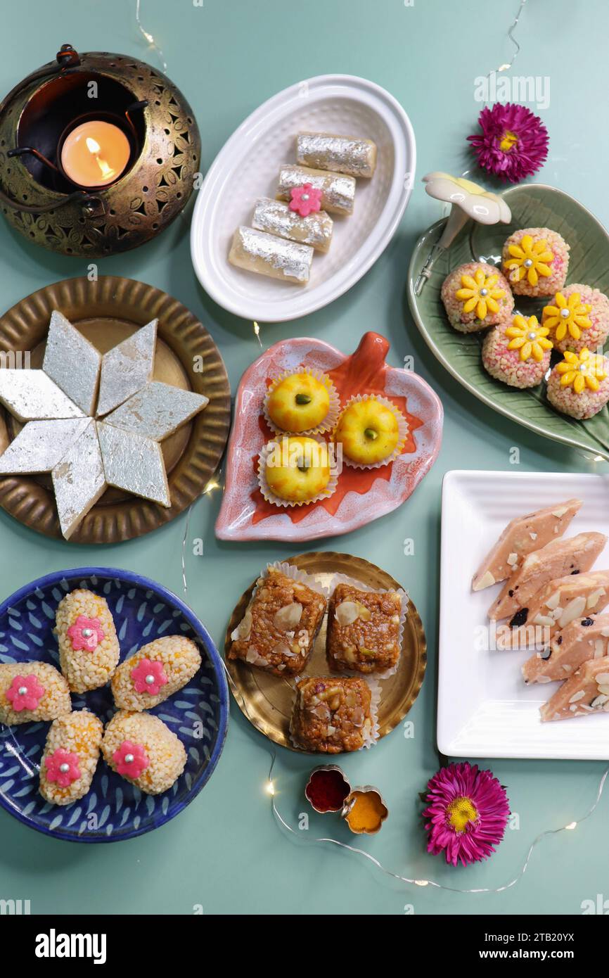 Indian assorted Diwali sweets or mithai with diya and flowers. Festive ...
