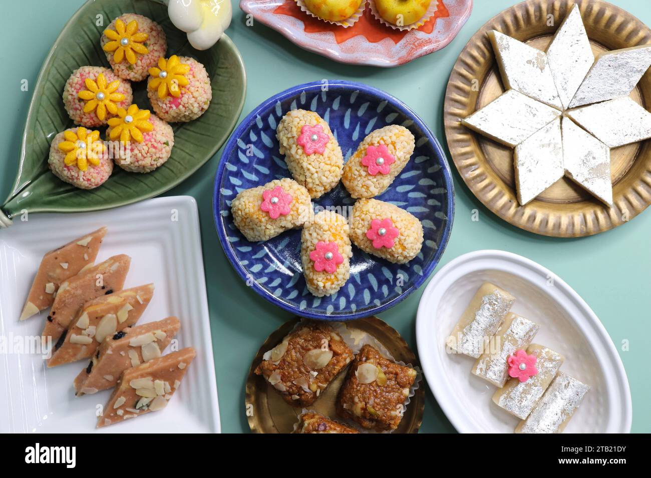 Indian assorted Diwali sweets or mithai with diya and flowers. Festive ...
